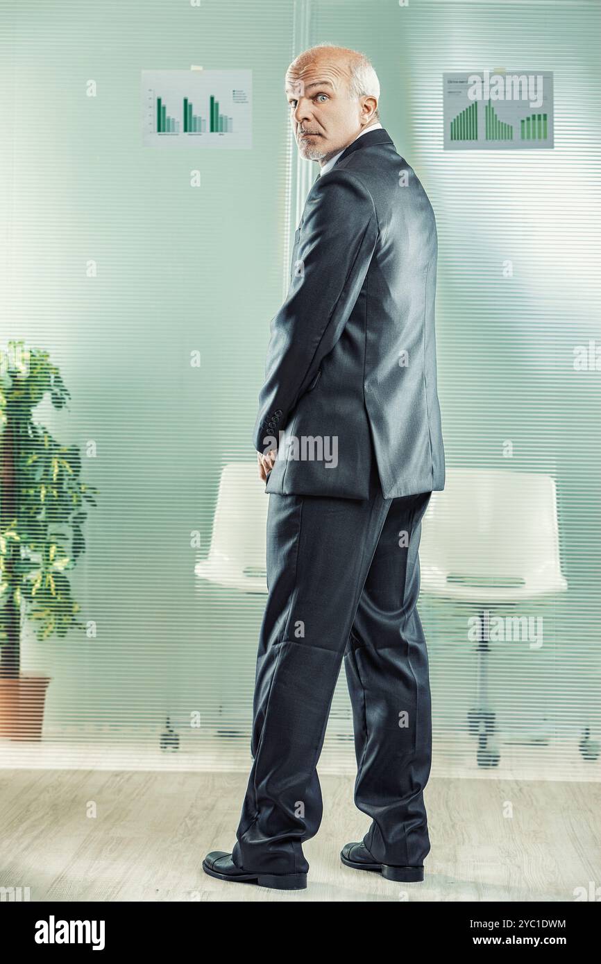 Businessman caught in an embarrassing act looks back guiltily, more ...