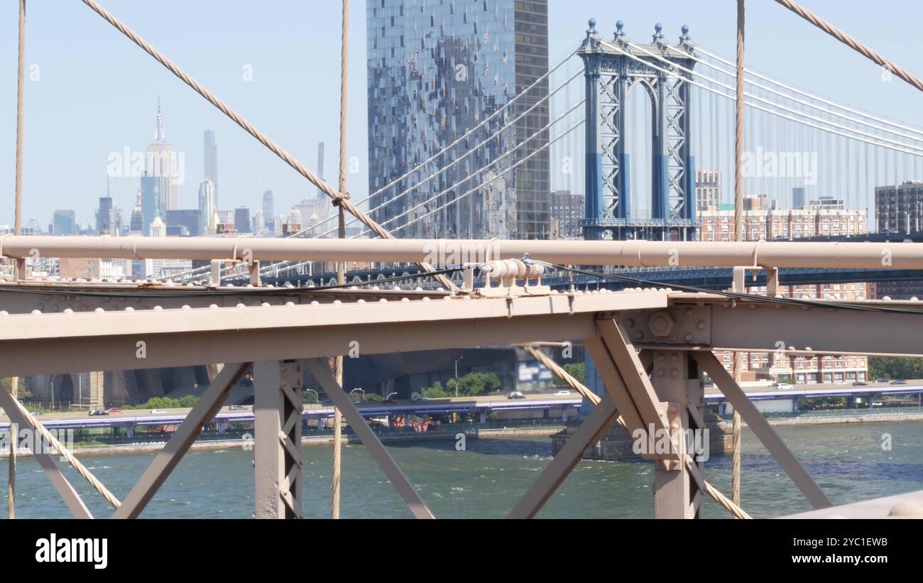 New York City Manhattan Bridge from Brooklyn Bridge view. Empire State ...