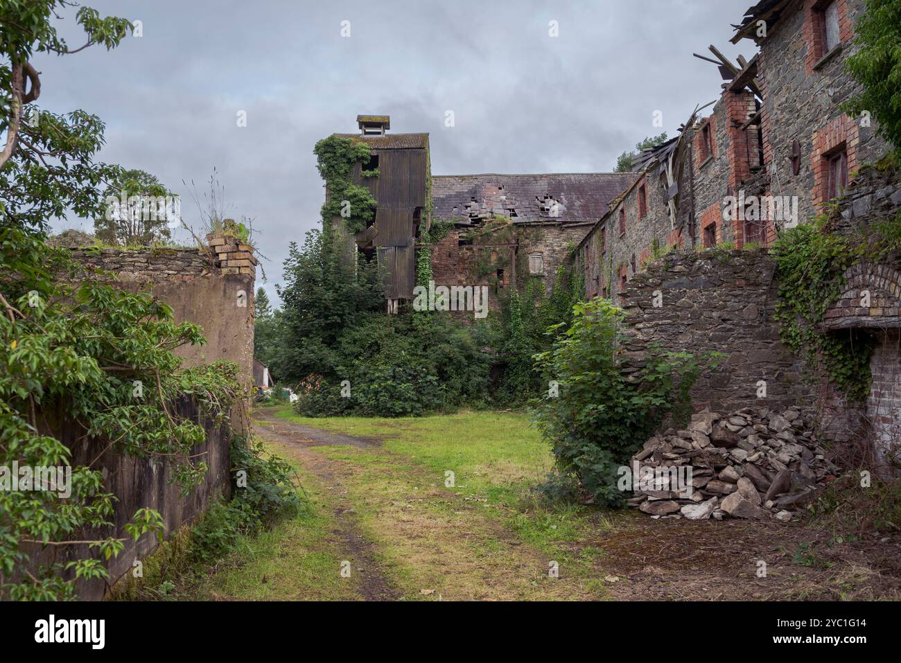 Ruins of an abandoned, industrial building shows crumbling stone and ...