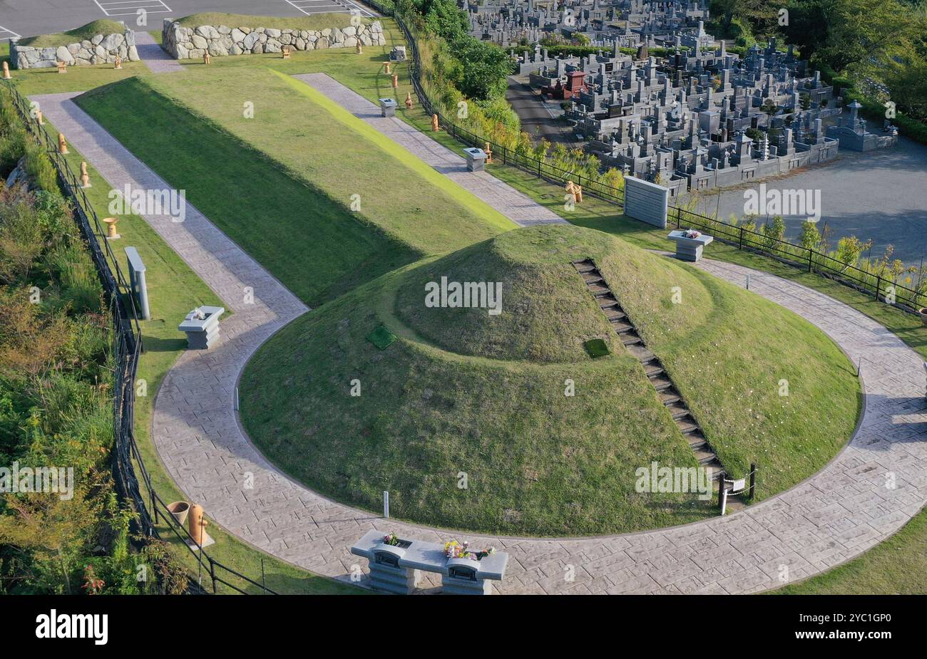 A photo shows a tomb modeled after keyhole-shaped tomb mound on a hill ...