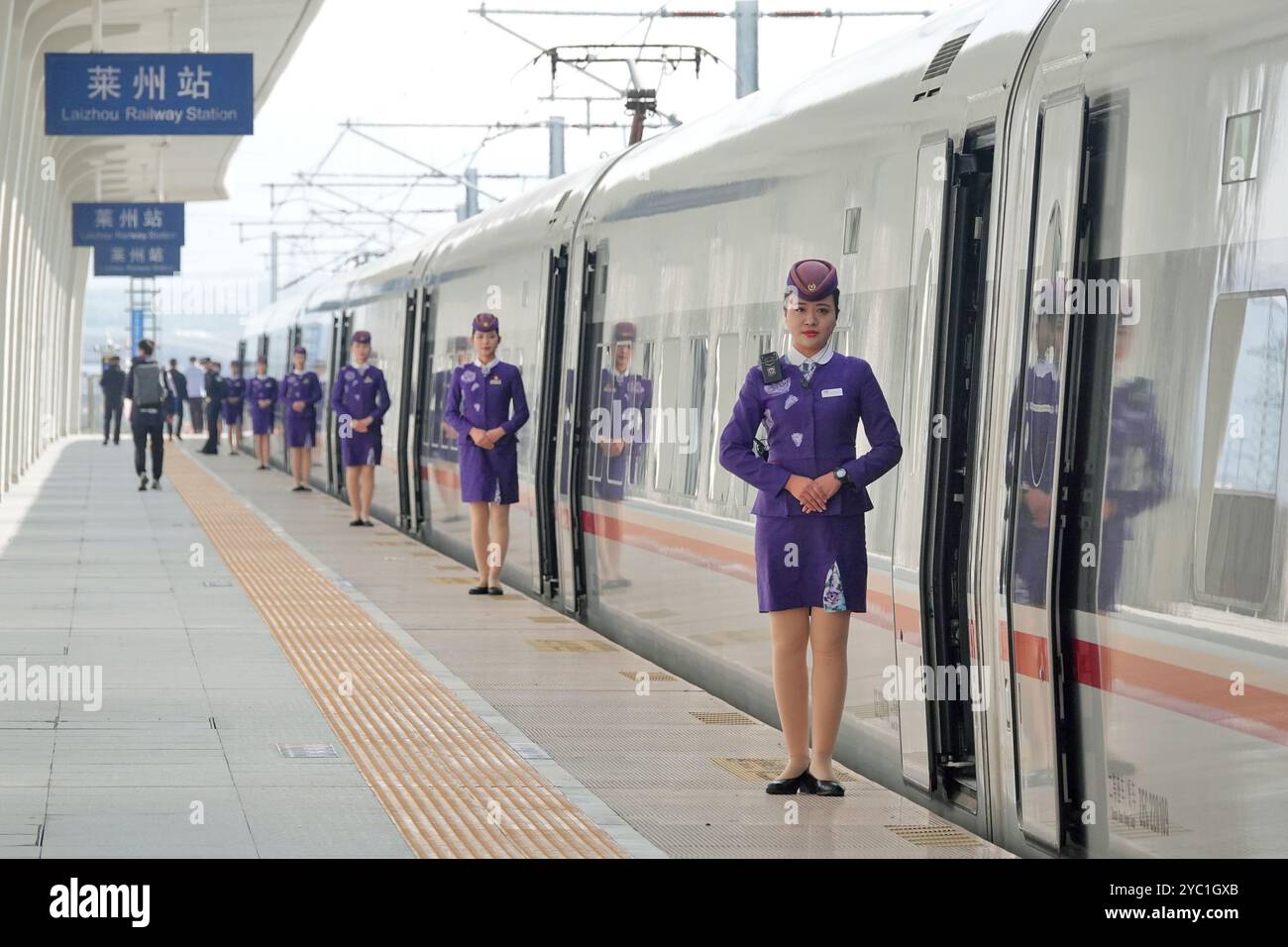 YANTAI, CHINA - OCTOBER 21, 2024 - A crew member welcomes passengers to ...