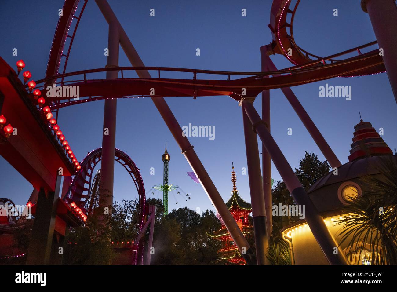 Roller coaster, chain carousel and pagoda at night, Tivoli Amusement ...