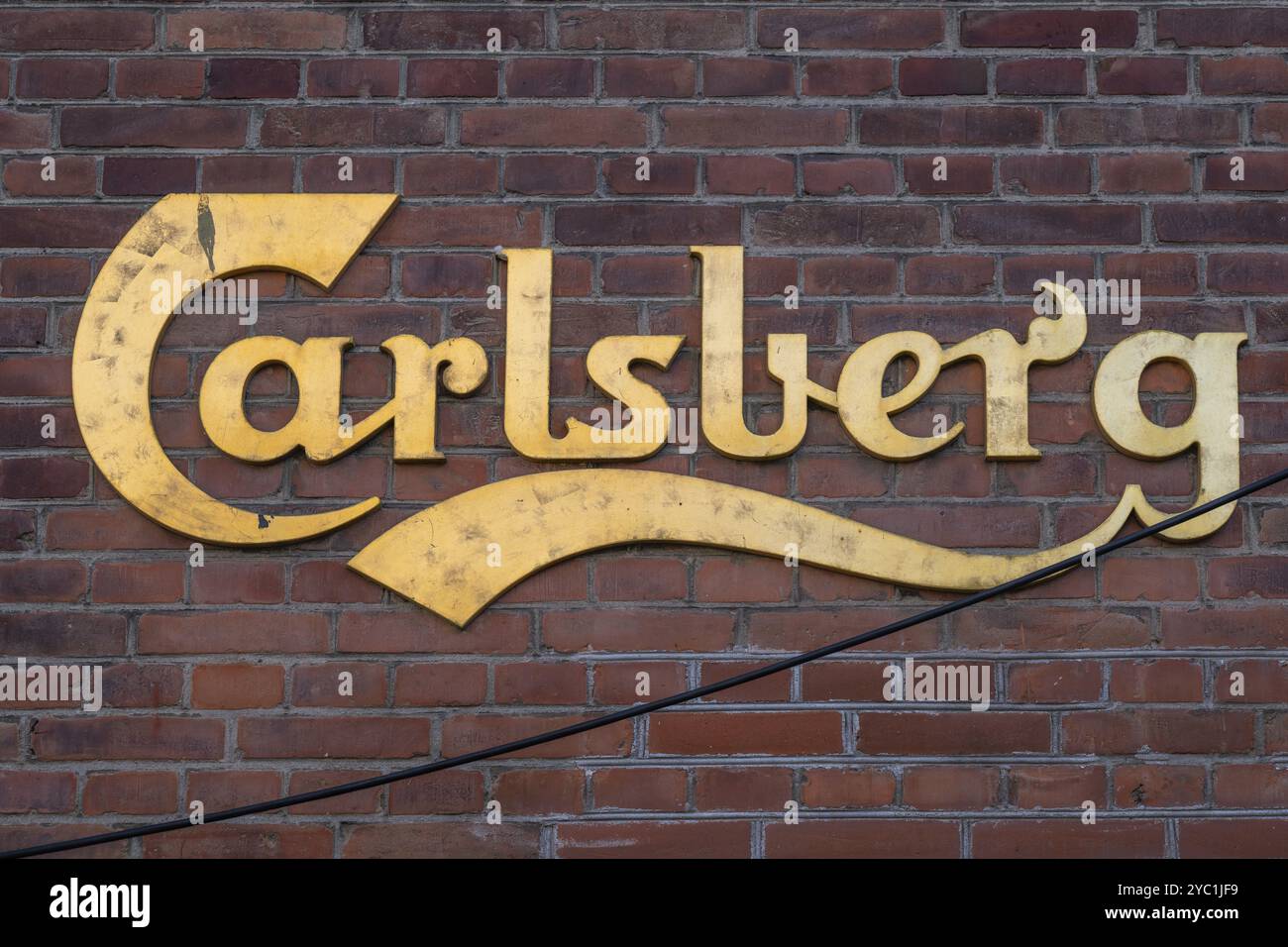 Golden Carlsberg Group logo on a brick wall, Carlsbergbygen, Carlsberg ...