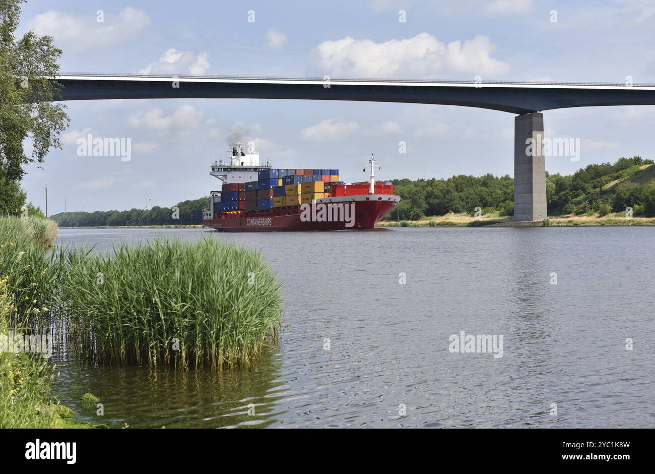 Containership Containerships VI sails under the motorway bridge of the ...