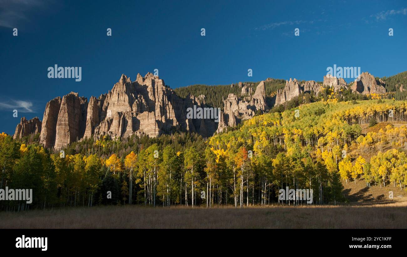 Aspens in color against cliffs and pinnacles of volcanic tuff near ...