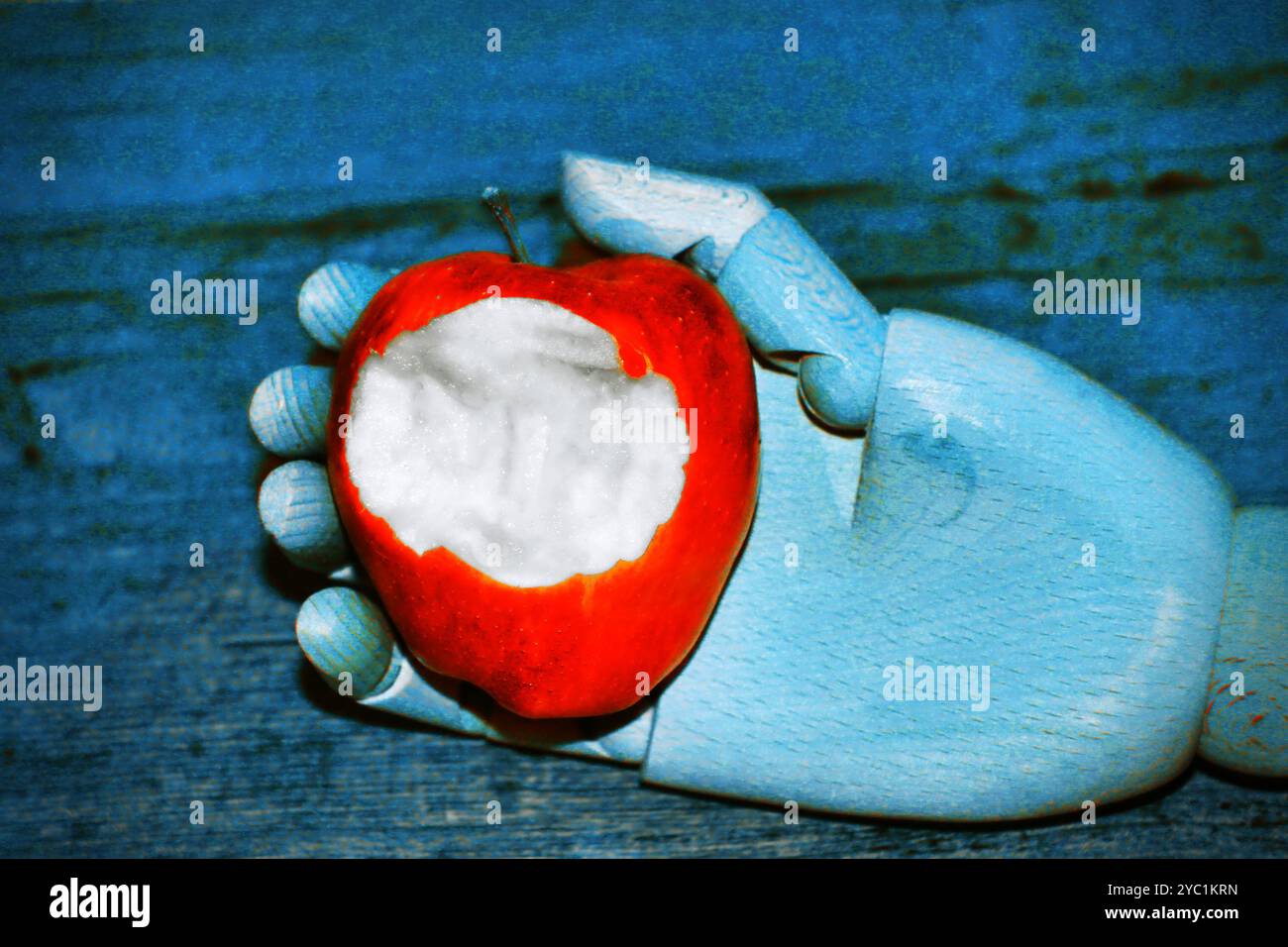 Robotic arm holding apple with a bite Stock Photo - Alamy
