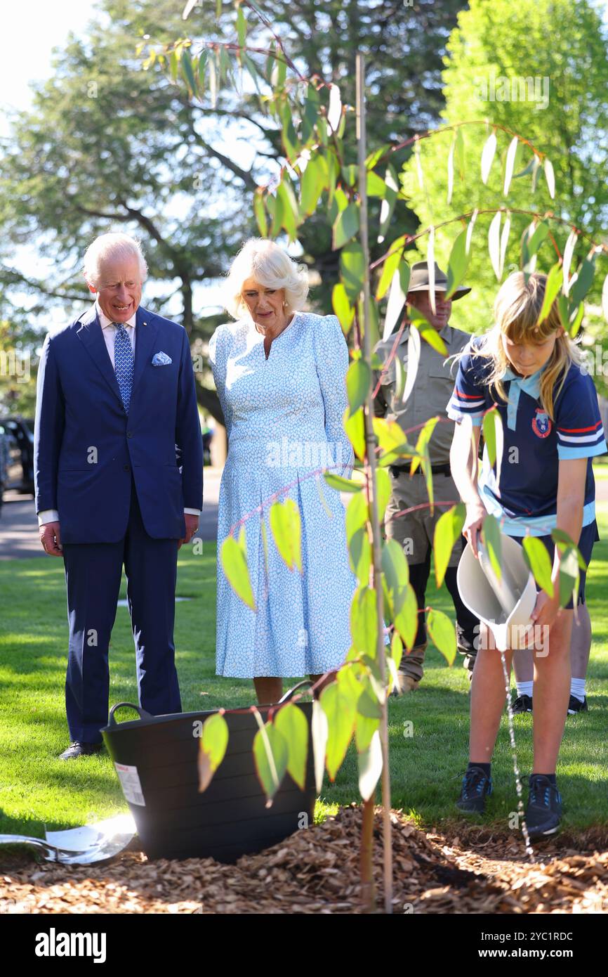 King Charles III and Queen Camilla stand nearby as Imogen Kimble, a student of Wamberal Public ...