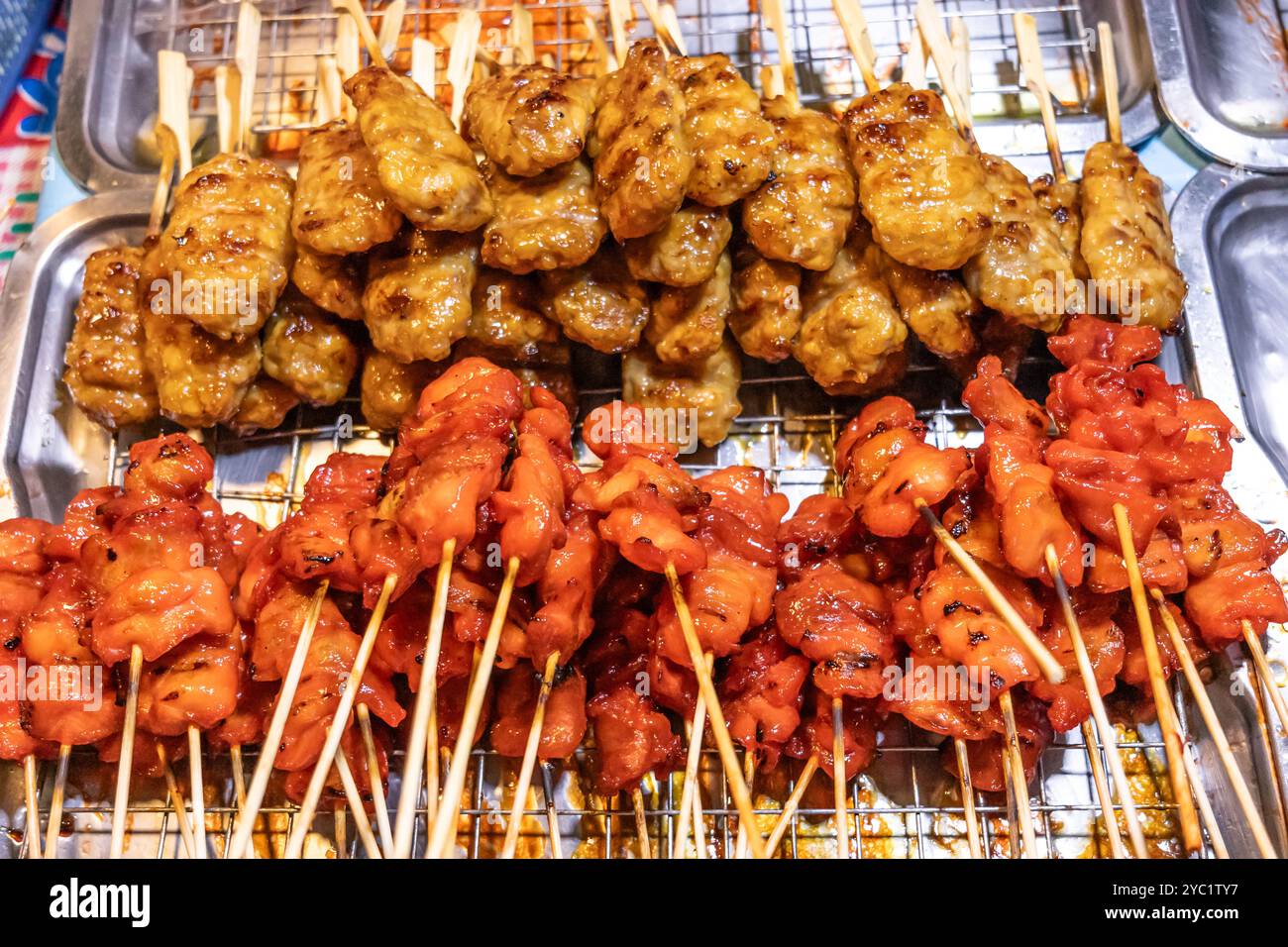 Traditional Asian meat satay street food cooking outdoor at night ...