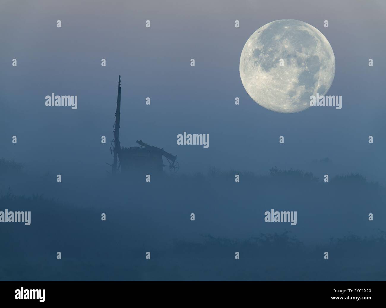 The October 'Hunters' Moon setting on a misty morning over the relic of ...