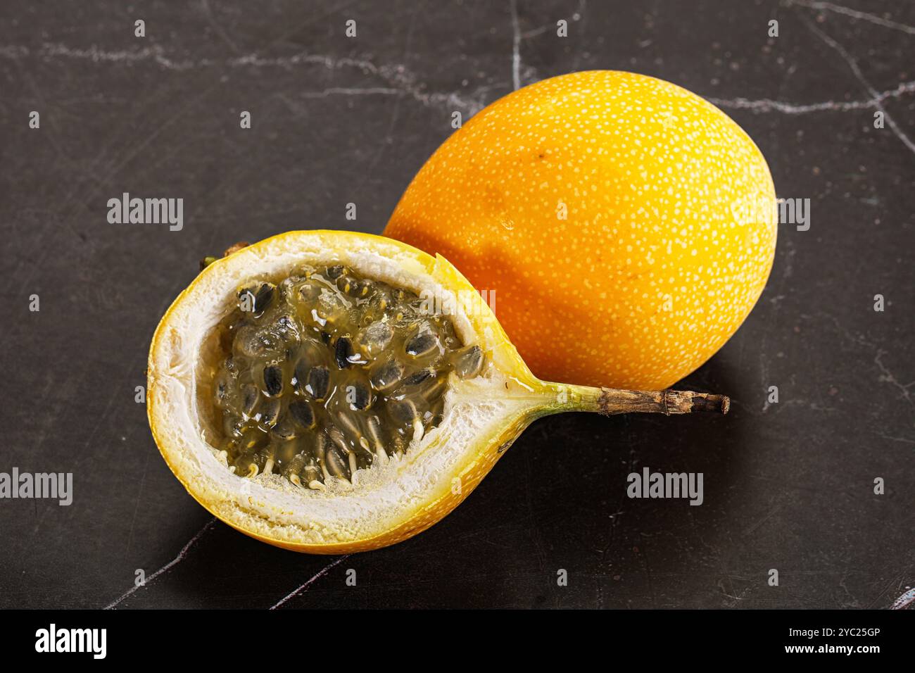 Yellow granadilla fruit with cut half Stock Photo - Alamy