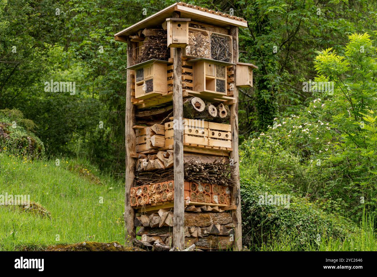 Tall Bee hotel tower made with wood, straw and clay standing in the ...