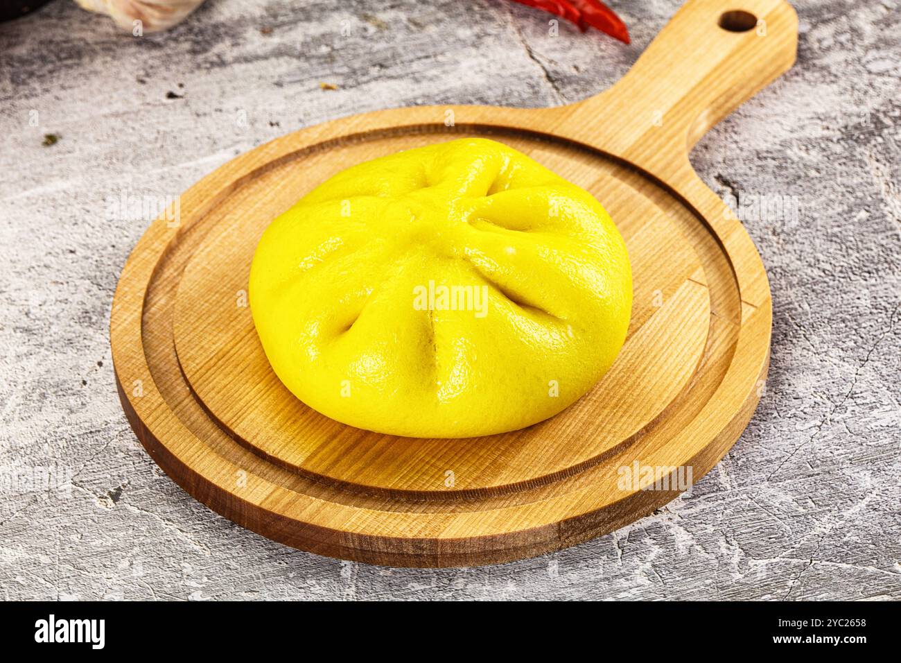 Asian stuffed steamed yellow Bun Bao Stock Photo - Alamy