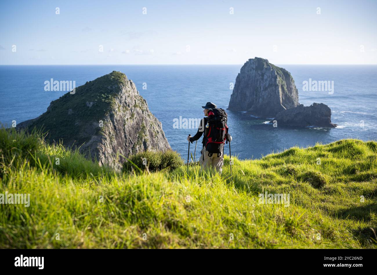Backpacker hiking Cape Brett Walkway. The island with the Hole in the ...