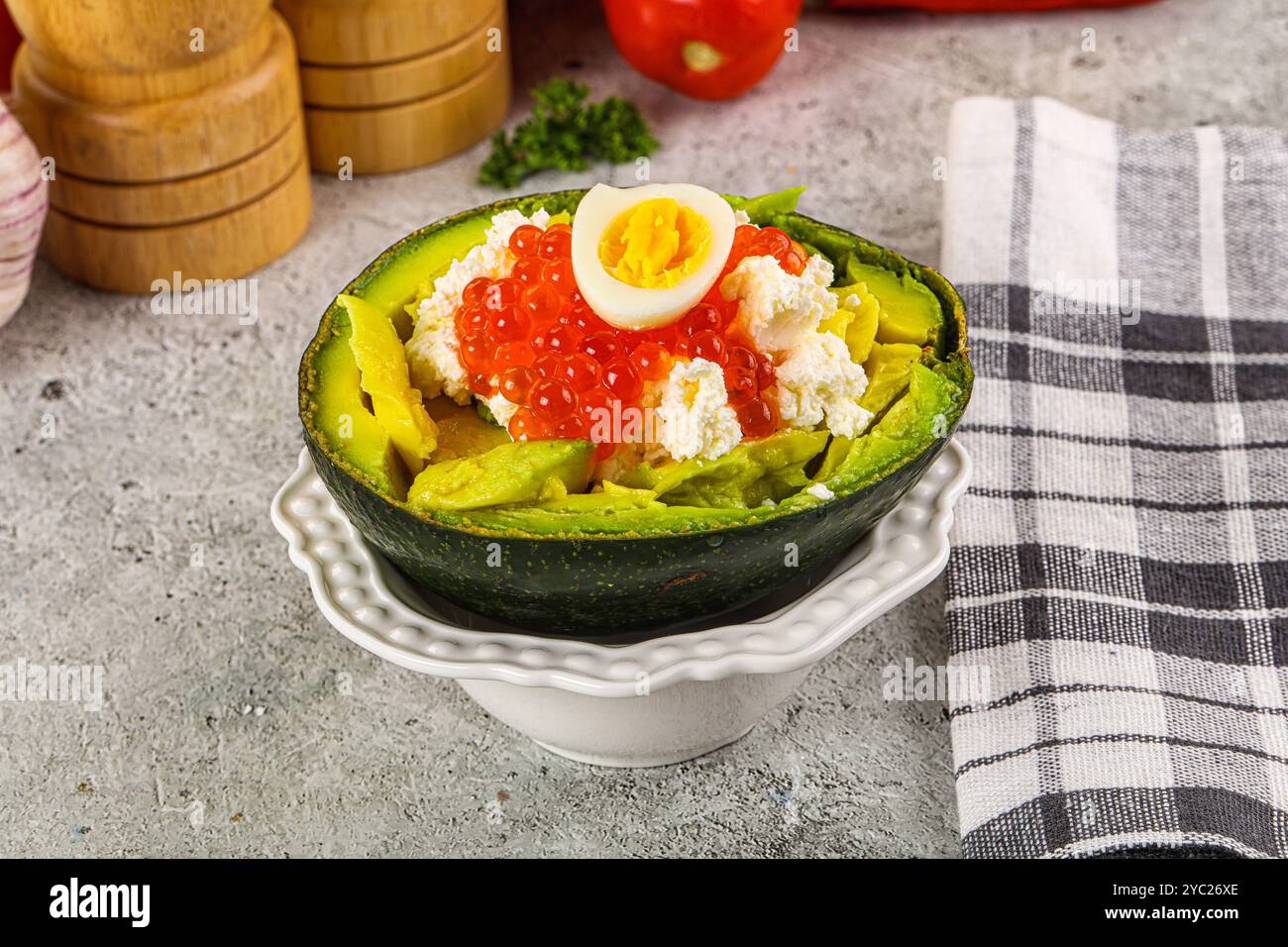 Avocado with red caviar and quil egg and soft cheese Stock Photo - Alamy