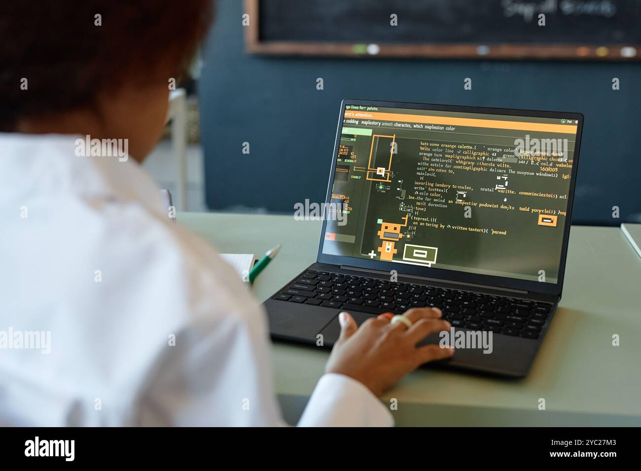 Over shoulder view of unrecognizable young girl using laptop with ...