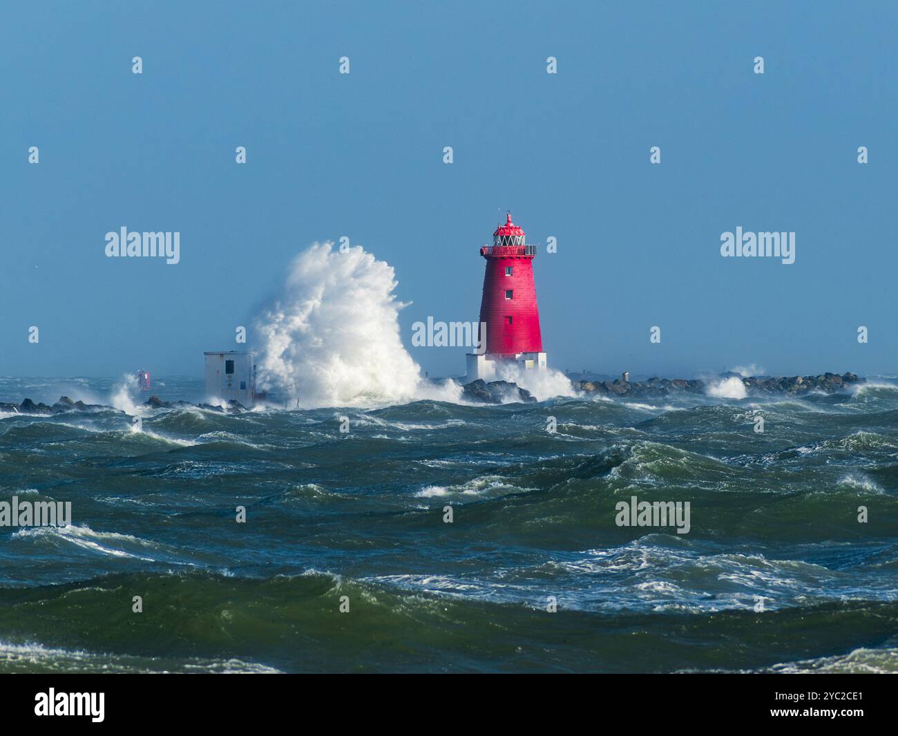 Wave hitting the Half Moon swimming club at the Great South Wall during ...