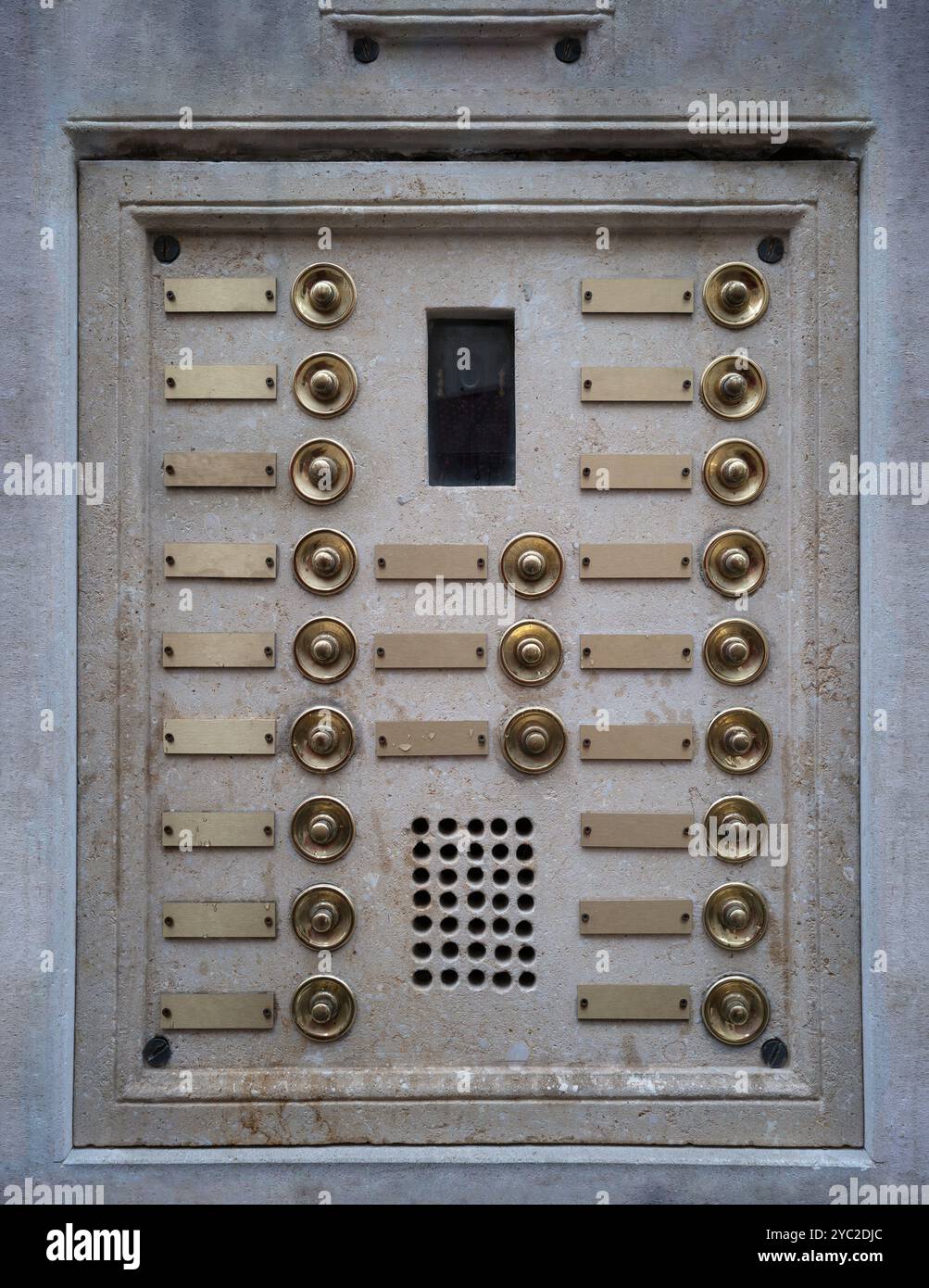 Ancient look bell buttons board against wall in bronze material with ...