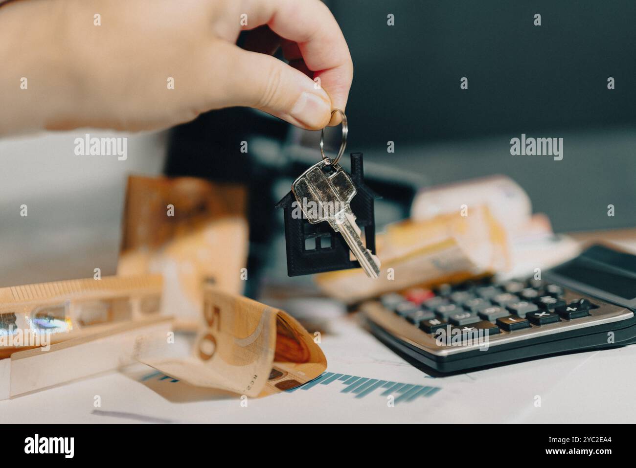 hand holding door keys real estate market home finance calculator ...