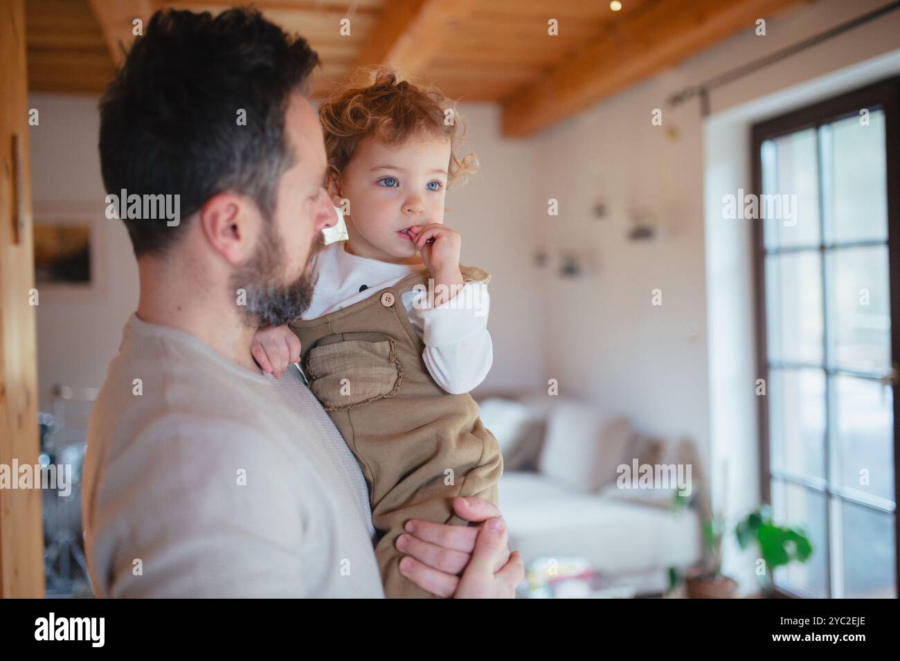 Sick girl with fever and cold at home. Father holding daughter in arms ...