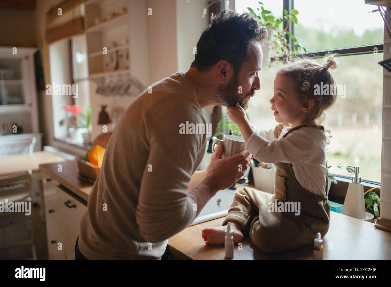 Sick girl with fever and cold at home. Father taking care of daughter ...