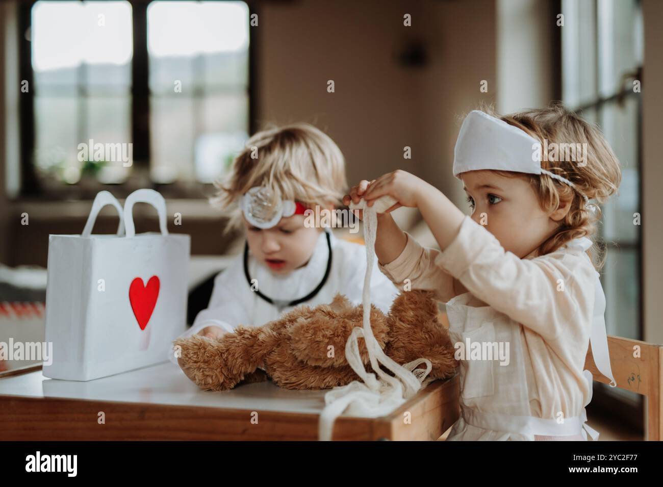Children playing doctor nurse treat hi-res stock photography and images ...