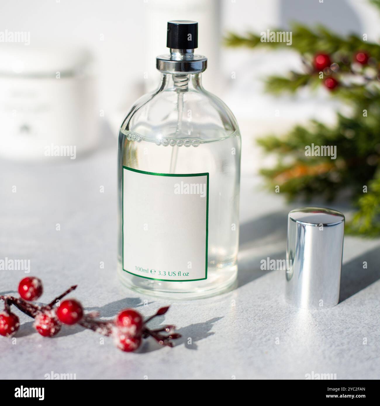 Perfume Bottle in Sunshine with Christmas greenery and berries Stock ...