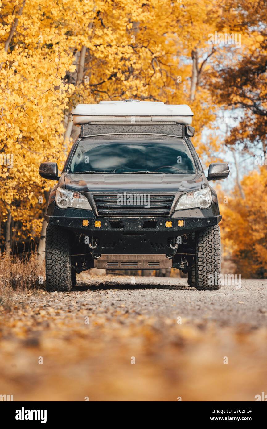 Modified Grey SUV On Dirt Road Surrounded By Fall Colors Stock Photo ...