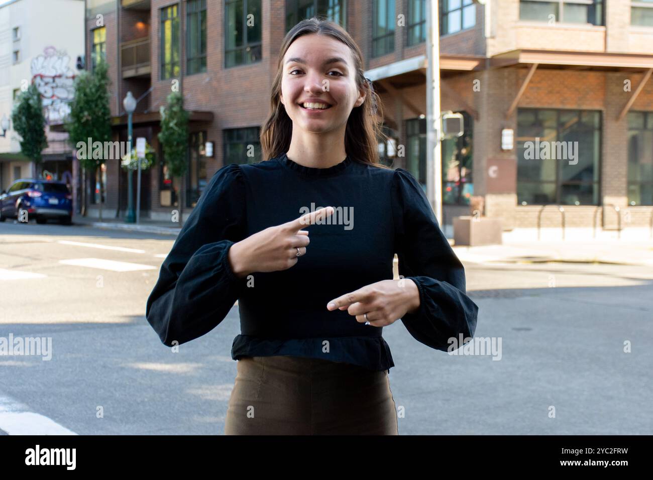 Sign Language Interpreter signs 'sign' in ASL Stock Photo - Alamy