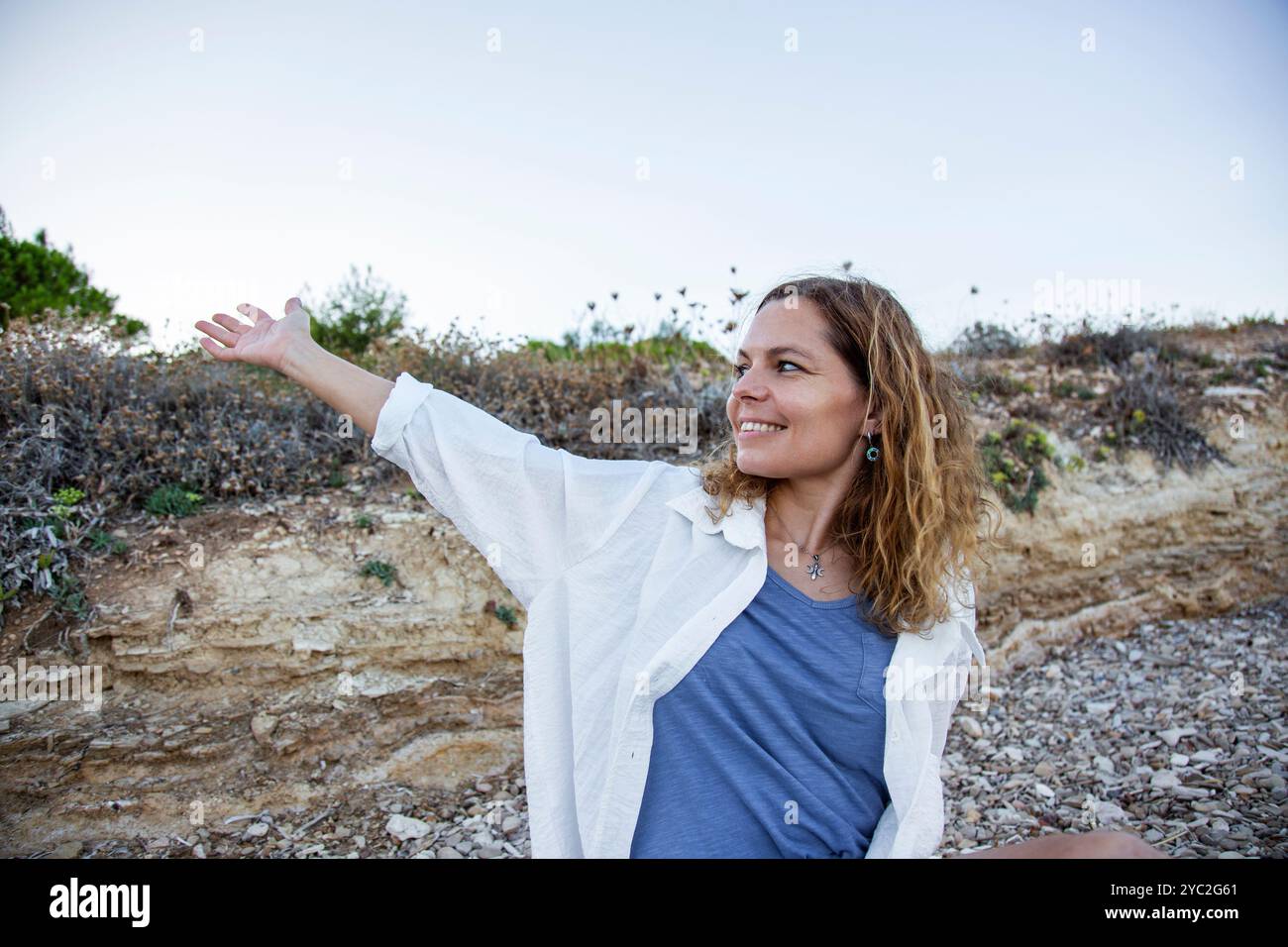 Woman extending arm on beach hi-res stock photography and images - Alamy