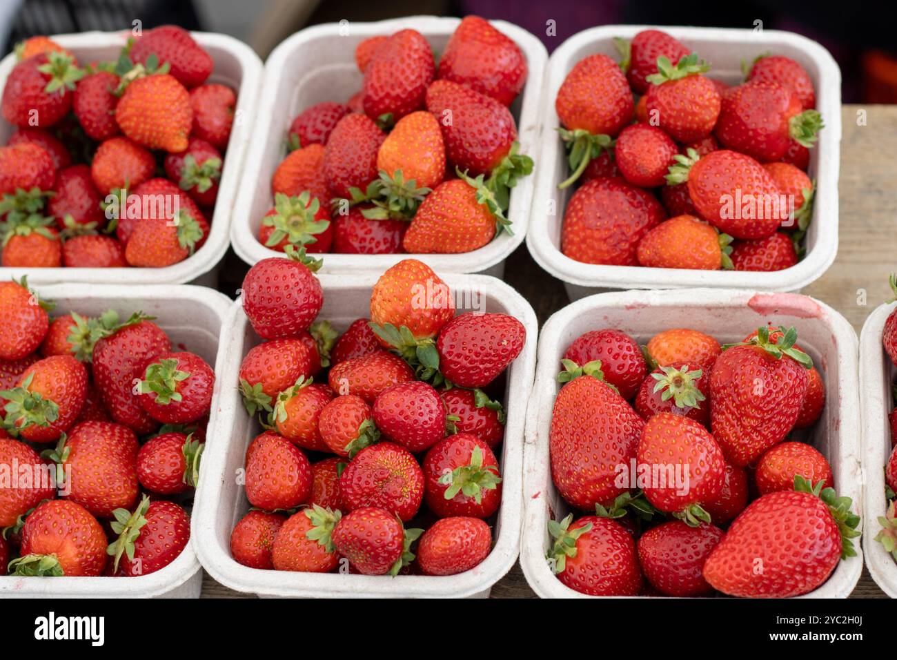 Fresh strawberries in cartons on display at a farmers market Stock ...