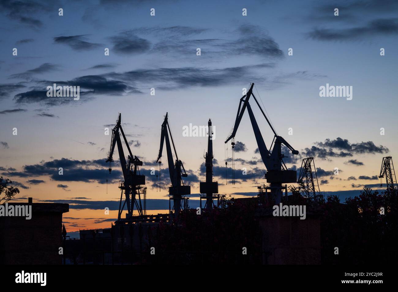 Silhouettes of Heavy Crains in Shipping Yard, Shipping Container City ...
