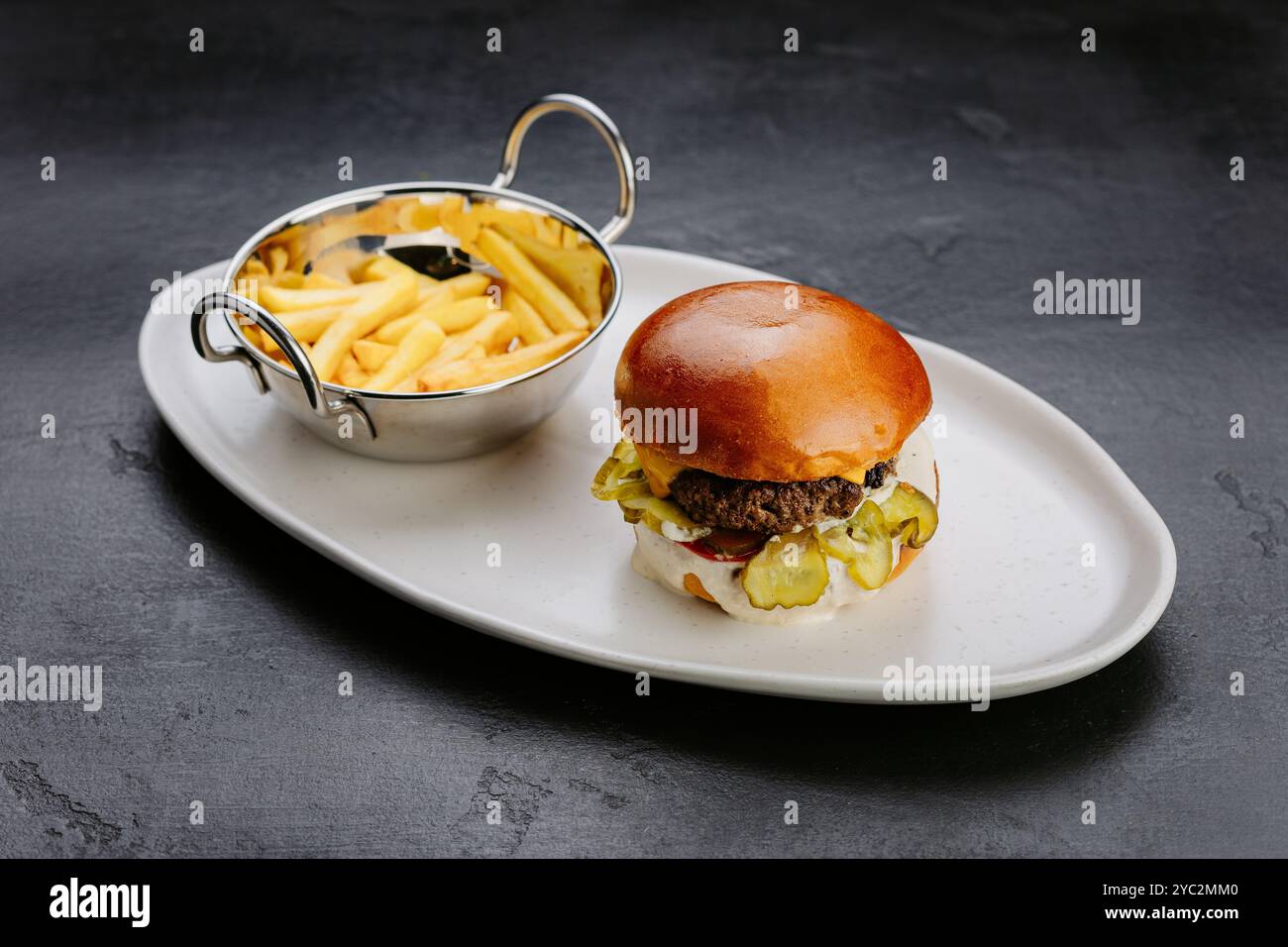 Juicy cheeseburger with pickles, creamy sauce, and soft bun, perfect ...