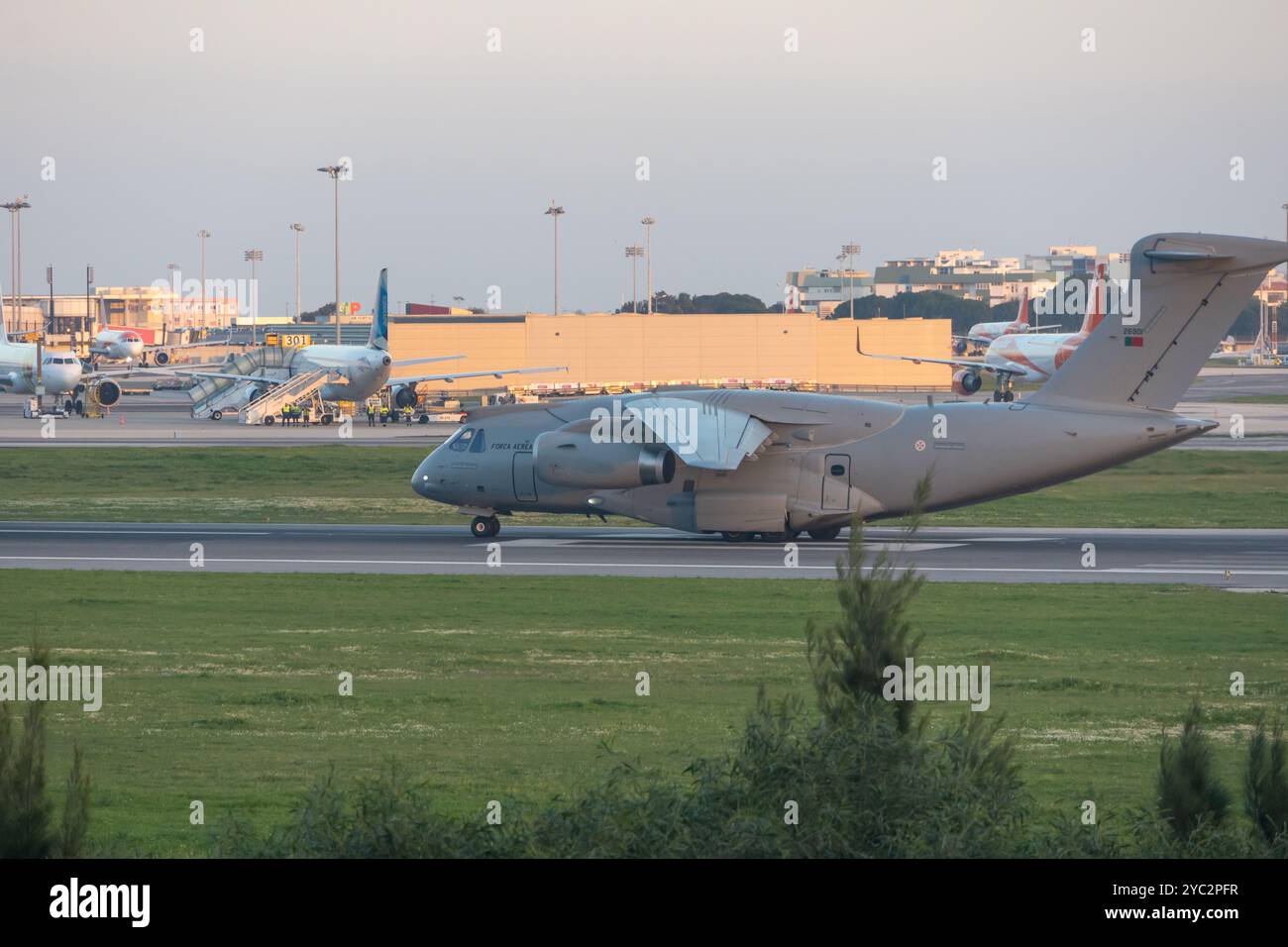 Modern military transport aircraft taxiing at lisbon airport at sunset ...