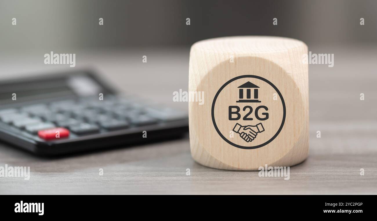 Wooden block with symbol of b2g concept and calculator on background ...