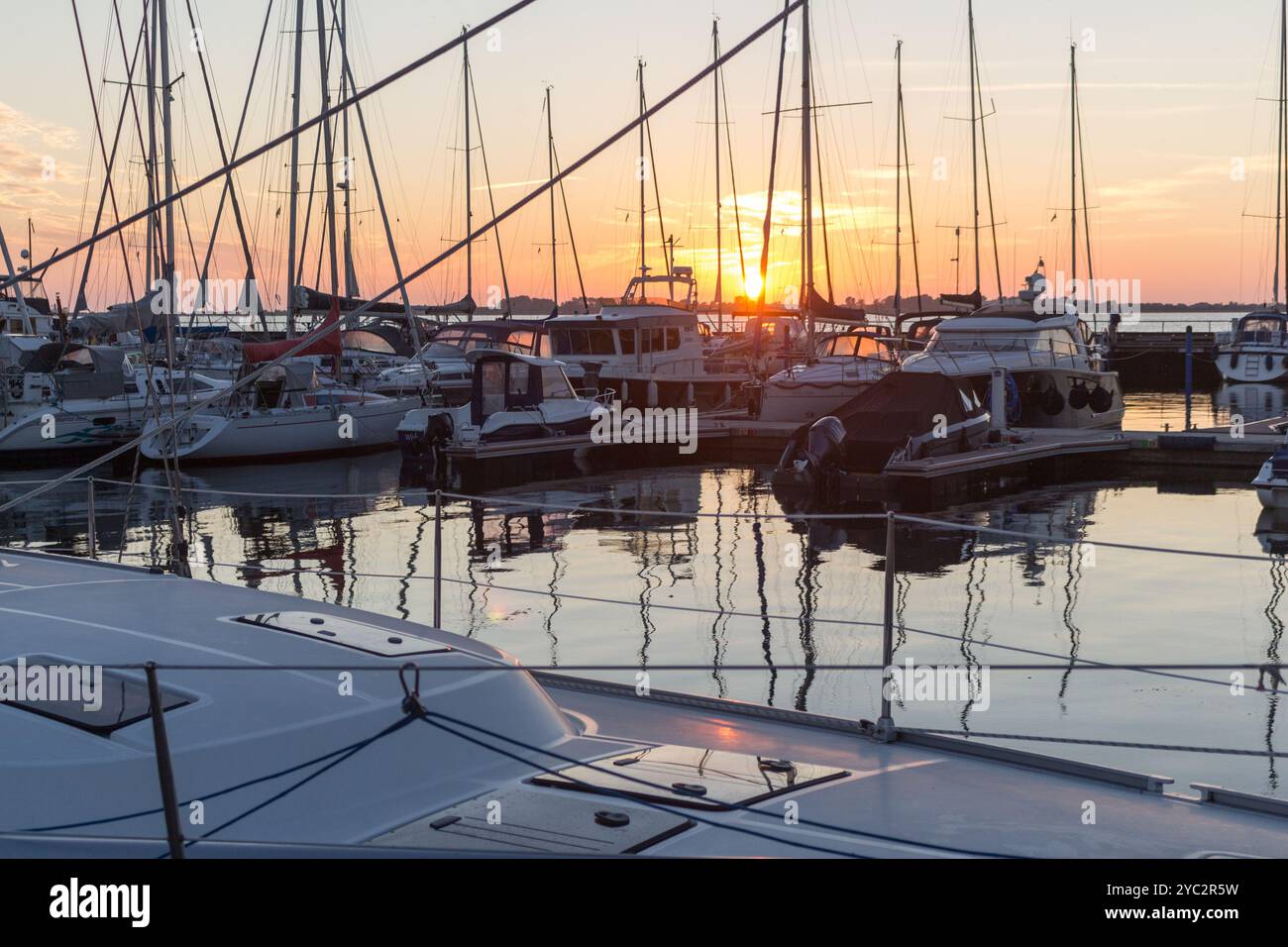 A peaceful sunset over Wiek Marina on the island of Rügen, Germany, as ...