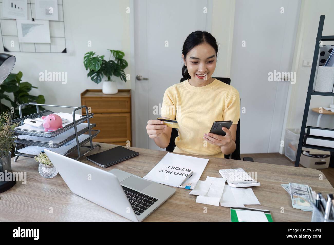 Young Woman Managing financial at Home Office with Smartphone and ...