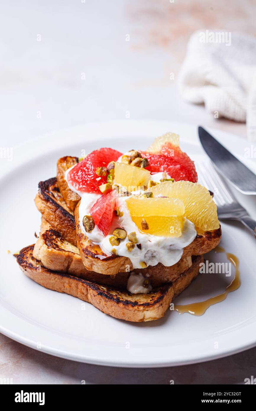 French toast with cream and citrus slices. European breakfast concept ...