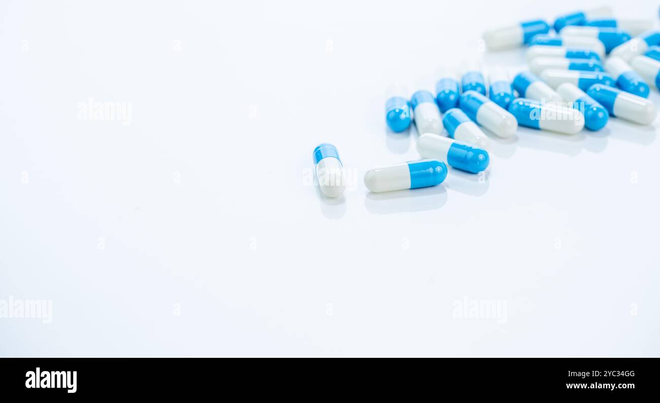 Blue-white capsules on white background. prescription drugs. Safety and ...
