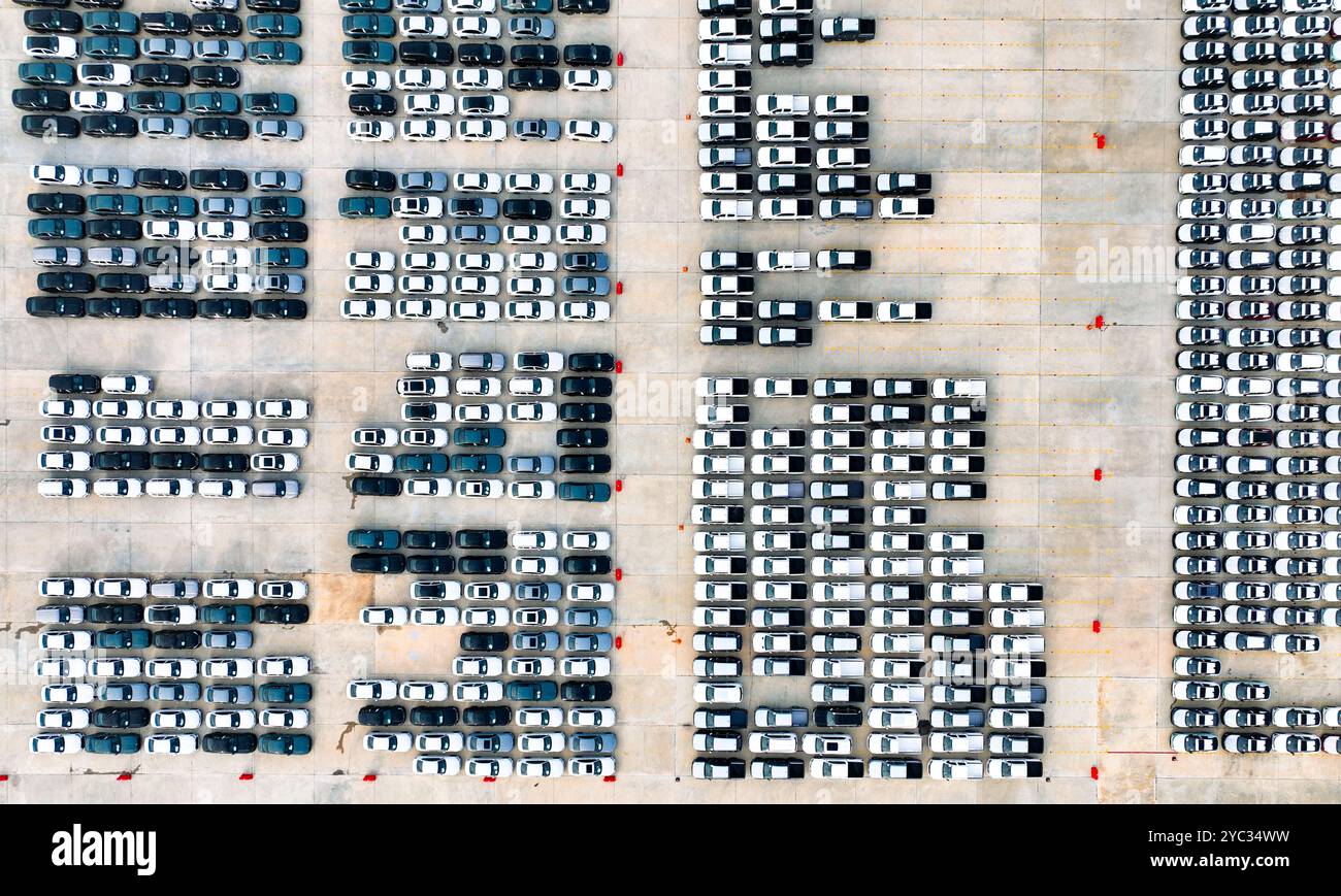 Aerial view of new cars stock at factory parking lot. Above view cars ...