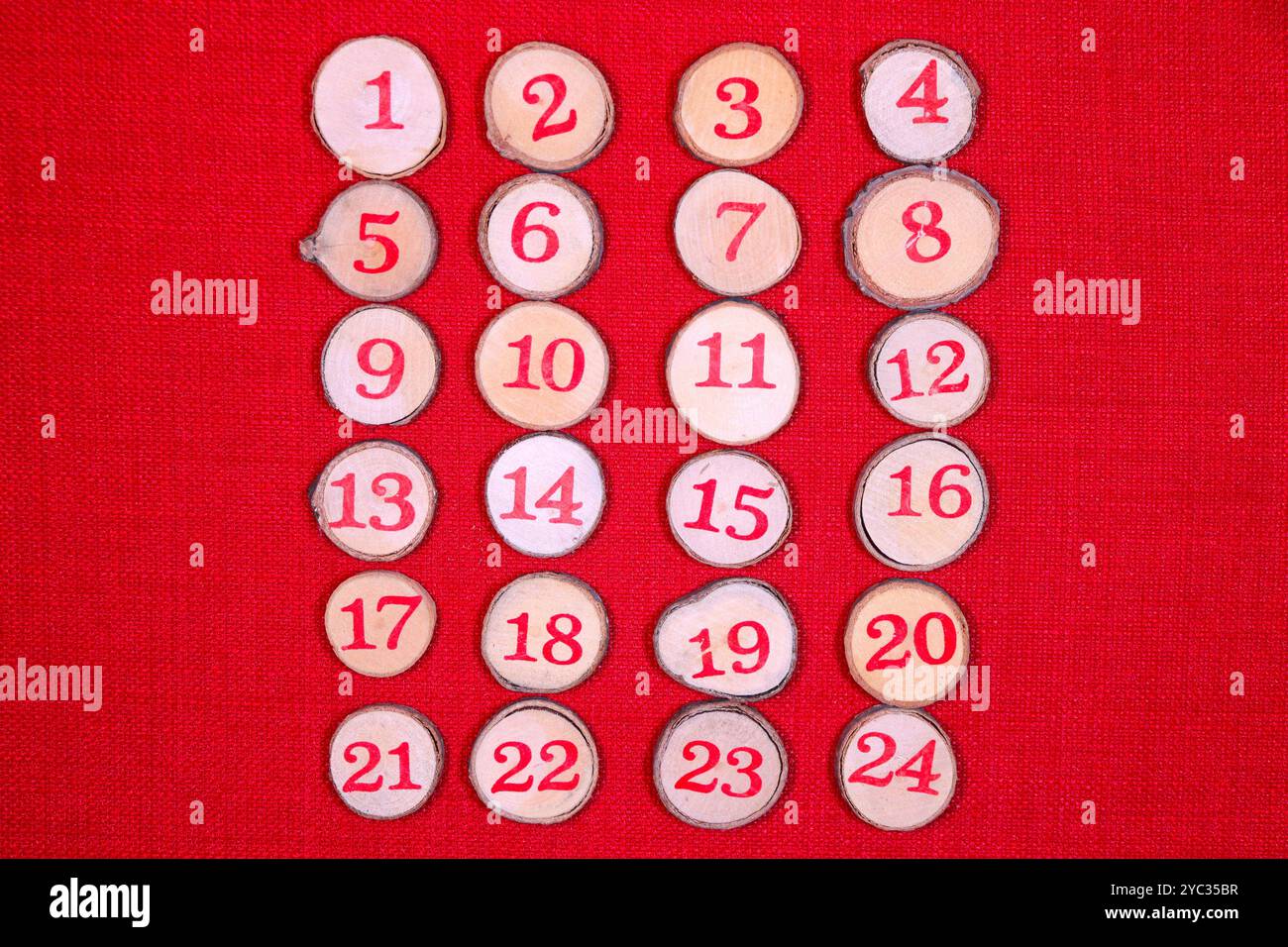 Wooden decorative 1 to 24 log button designs against a bright red ...