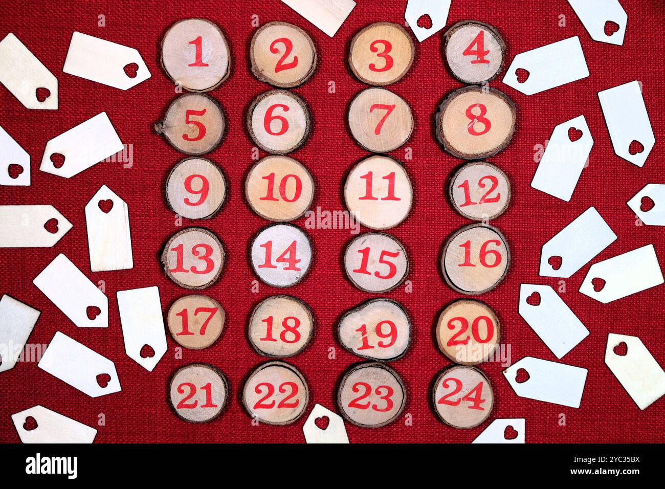 Wooden decorative 1 to 24 log button designs against a red stitch ...