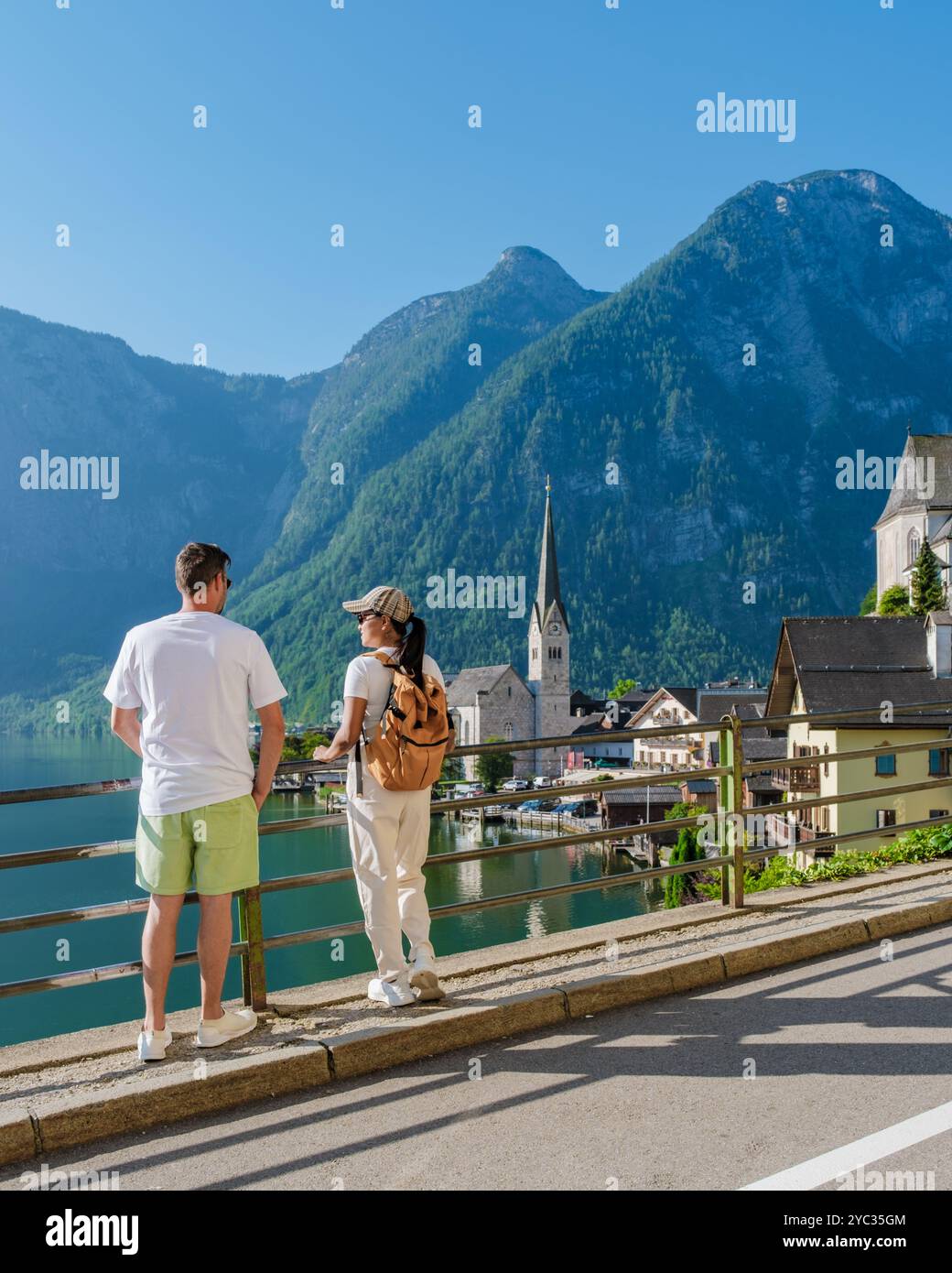 A couple admires the breathtaking beauty of Hallstatt, Austria. The ...