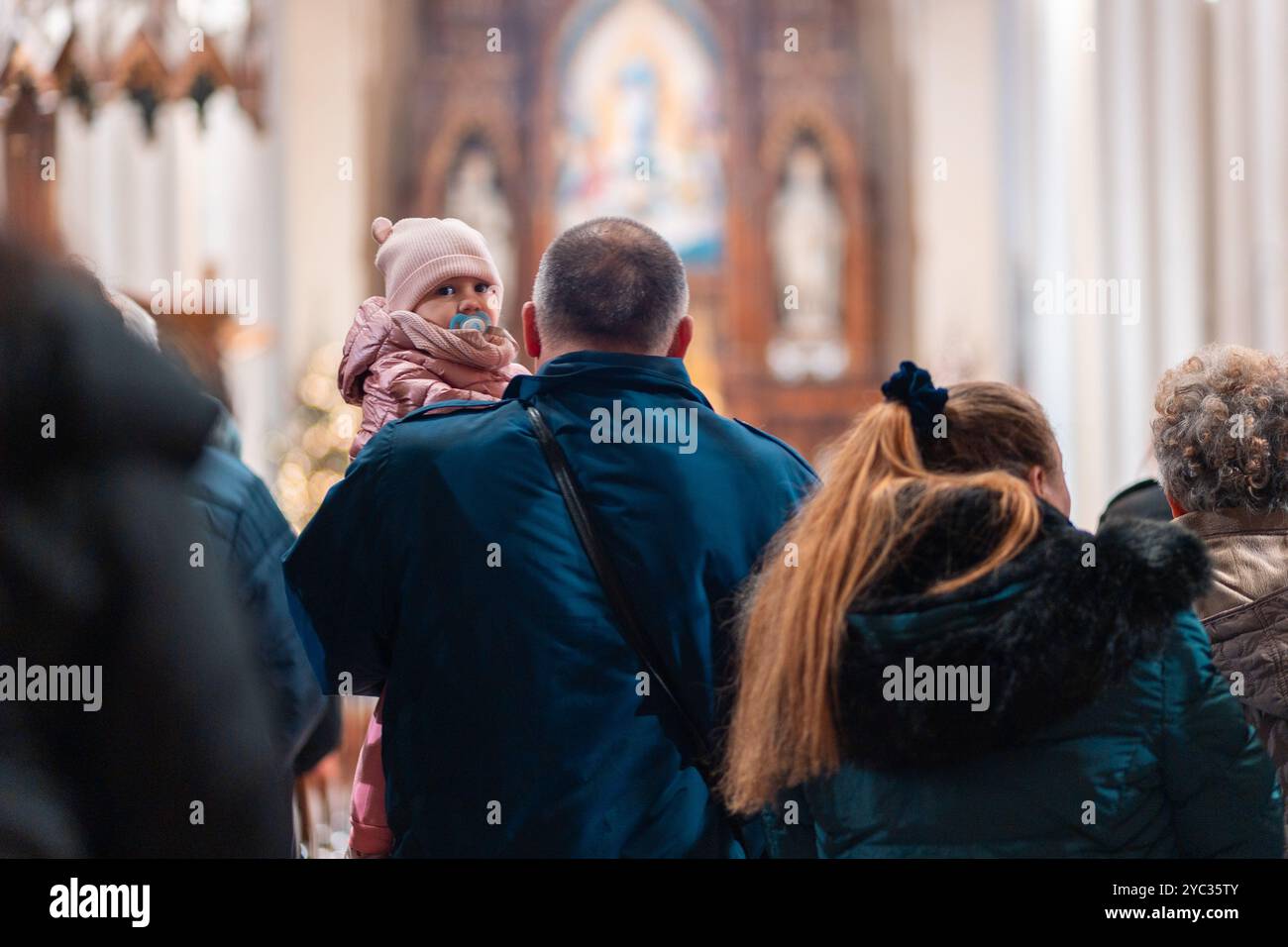 Church altar during Christmas Mass with The Nativity scene. Back view ...