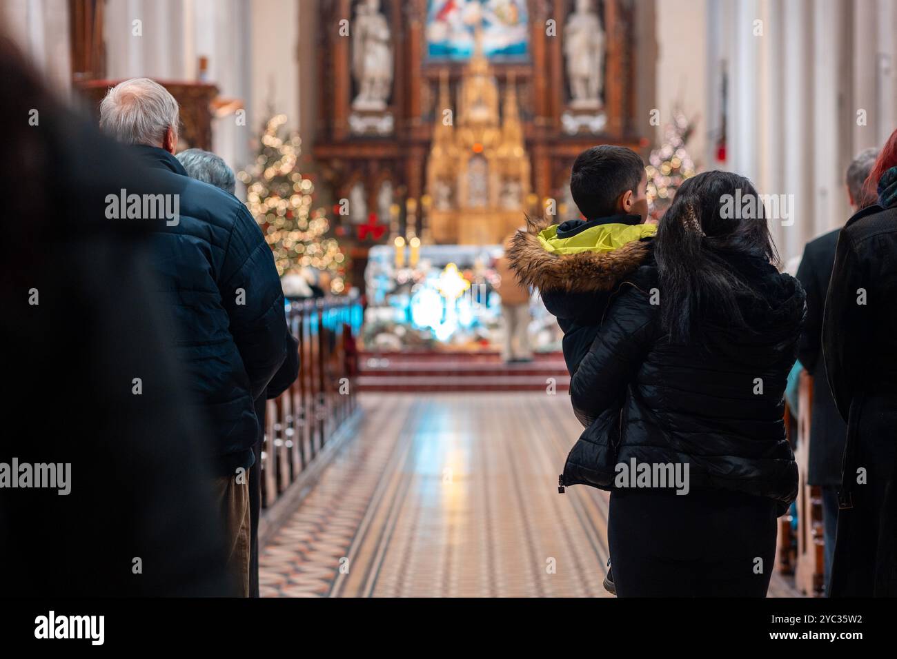 Church altar during Christmas Mass with The Nativity scene. Back view ...