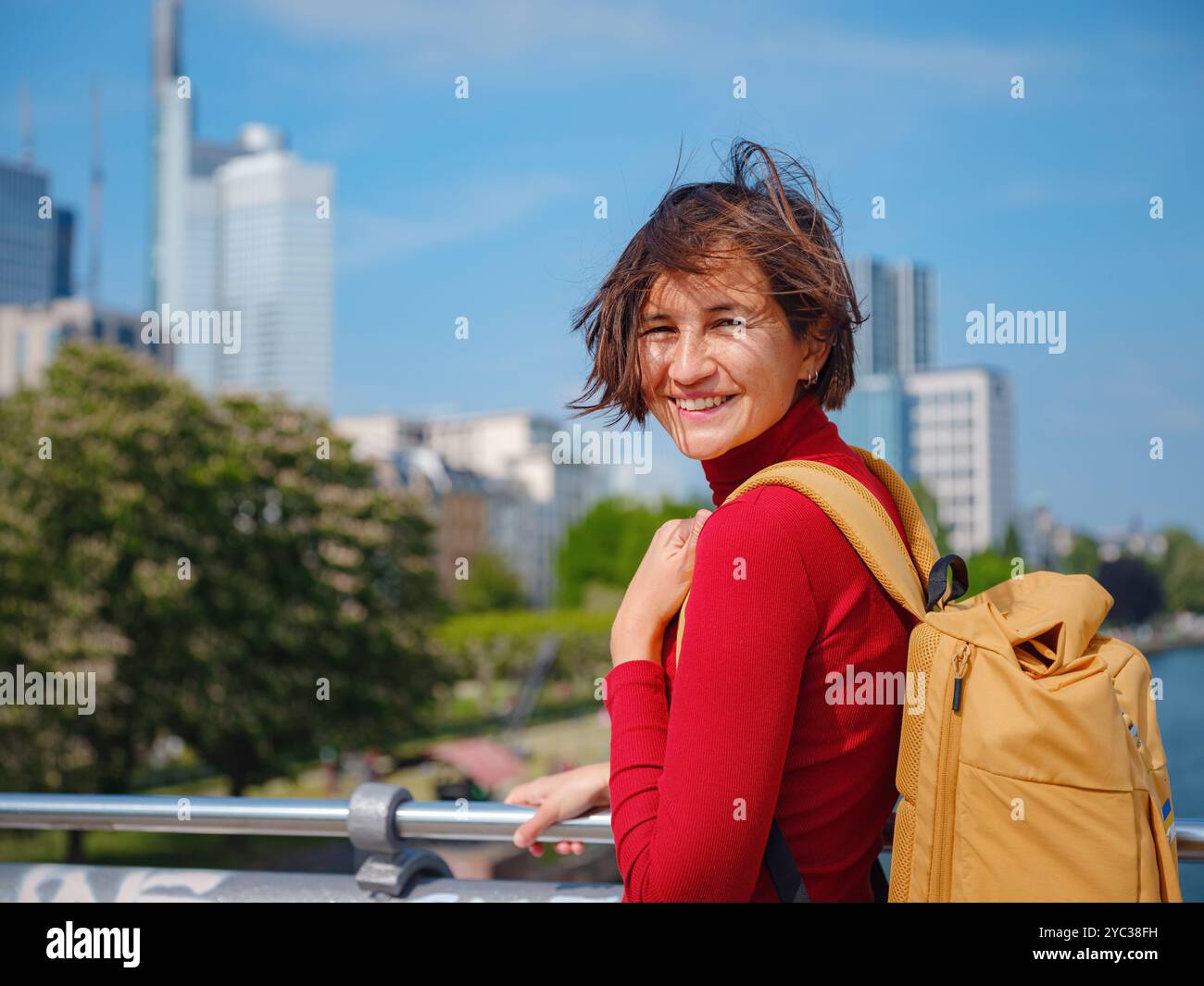 Tourist woman explores modern Frankfurt, walking through vibrant ...