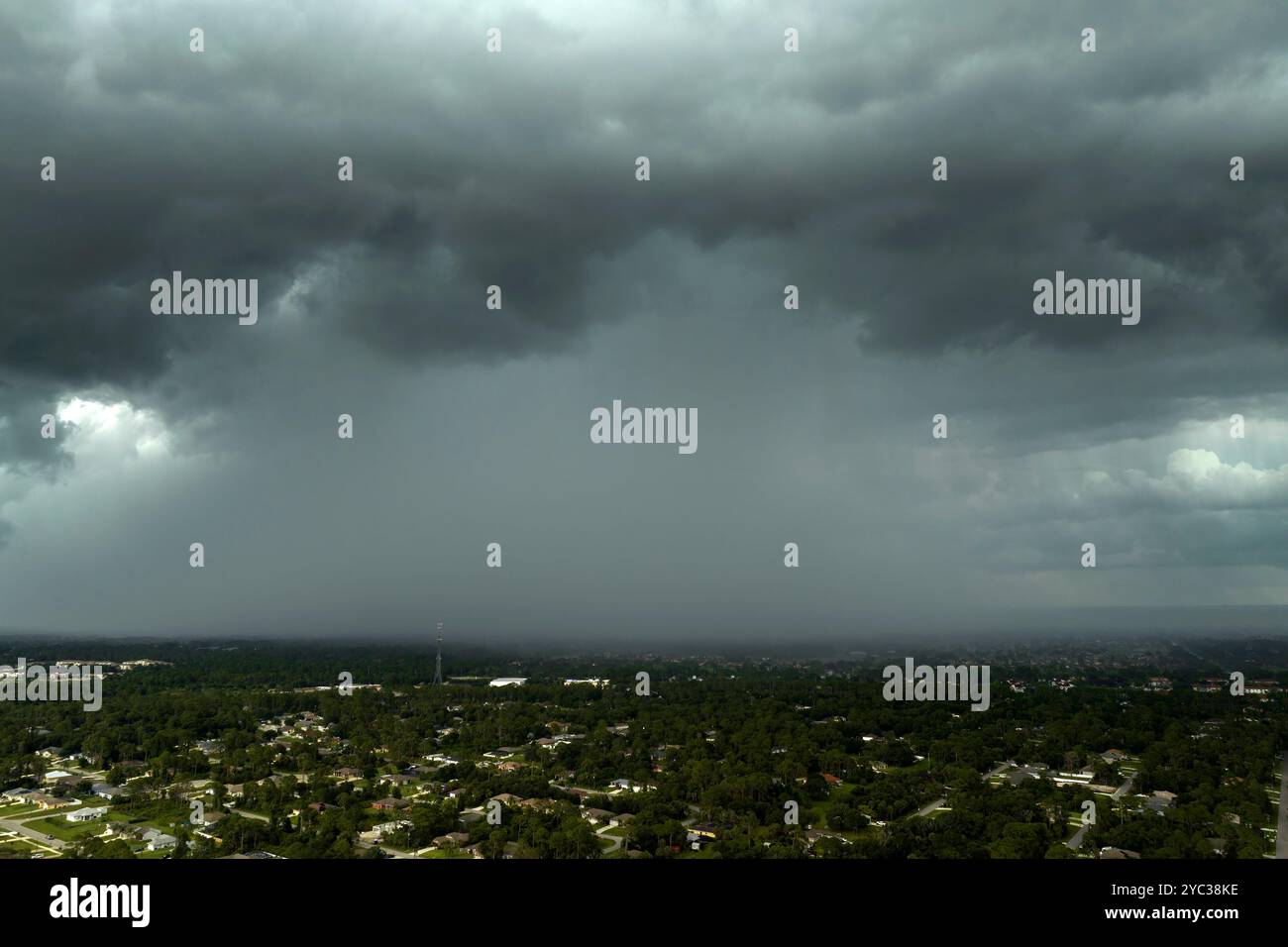 Heavy rain falling down from stormy clouds over rural Florida suburbs ...