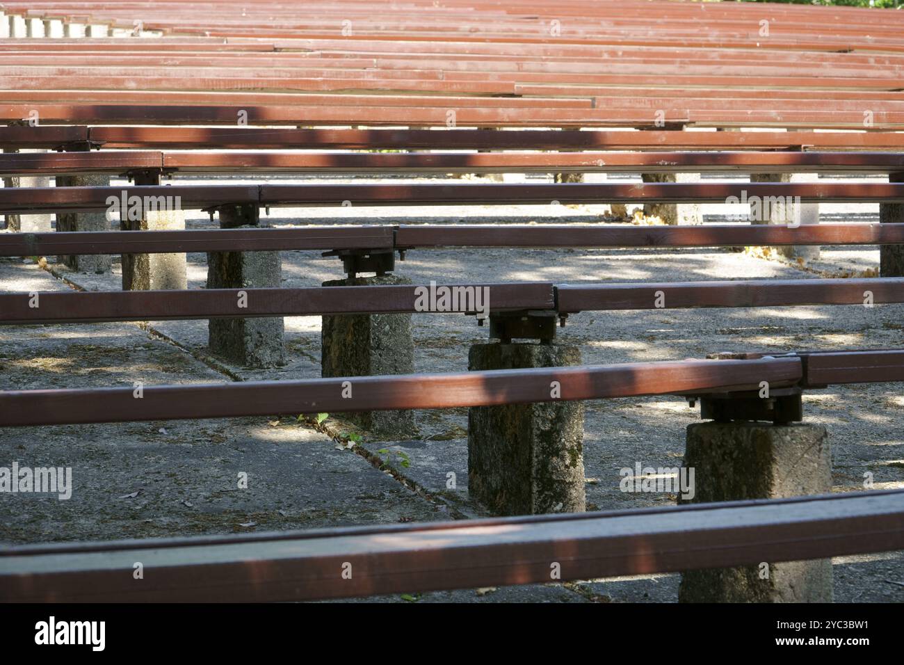 View of old-fashioned wooden benches in an outdoor amphitheater ...