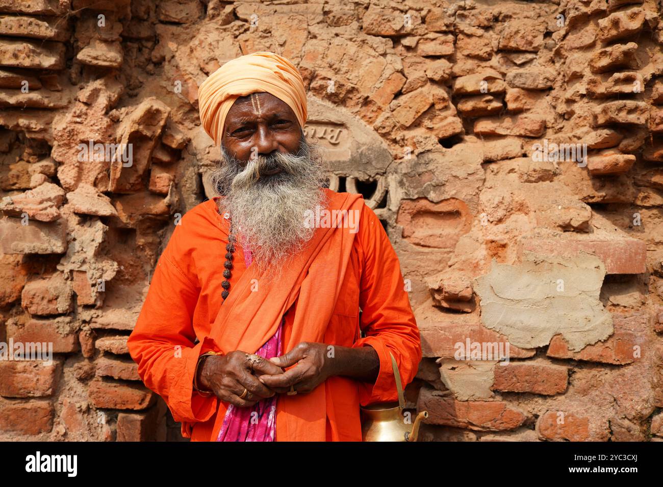 A sadhu poses before a dialopted terracotta mandir of Baidyapur. East ...