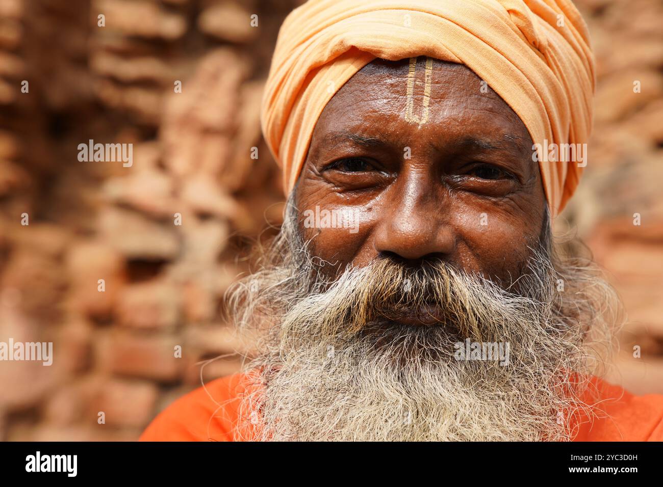 A sadhu poses before a dialopted terracotta mandir of Baidyapur. East ...