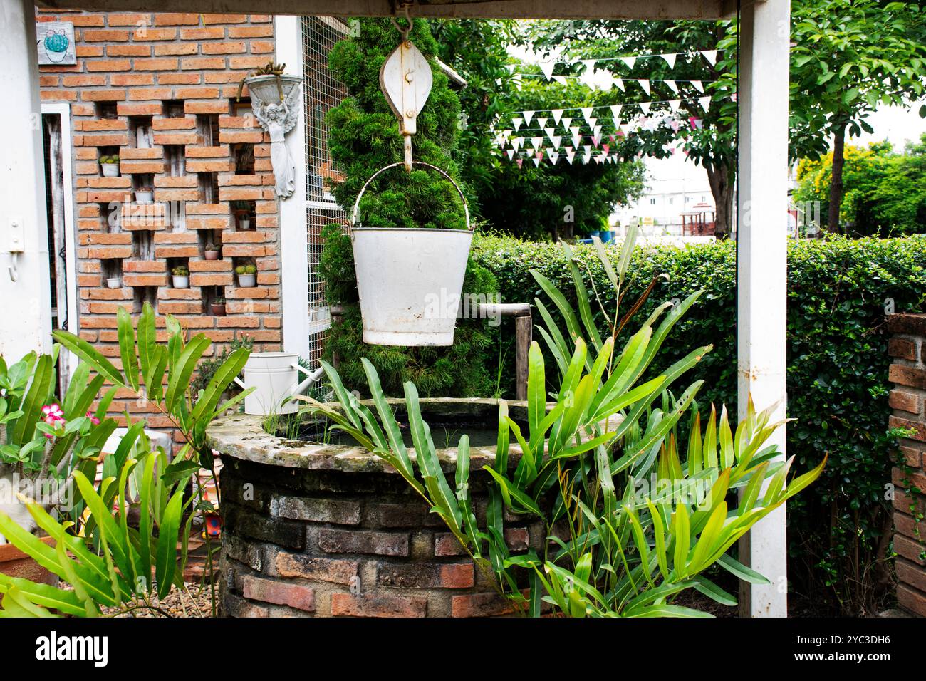 Classic vintage retro antique stone brick artesian water well and roof ...